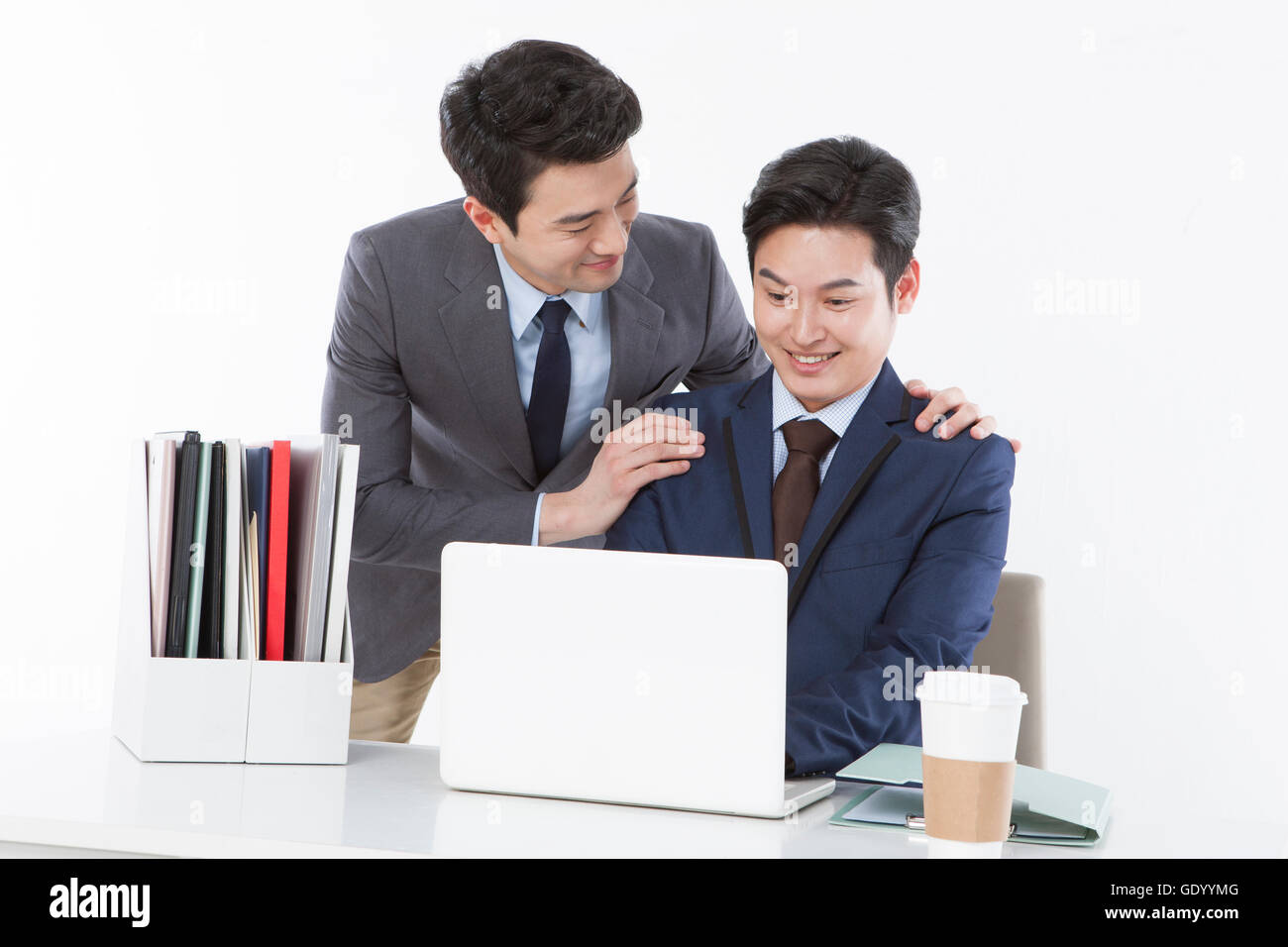 Portrait of two smiling businessmen at work Stock Photo - Alamy