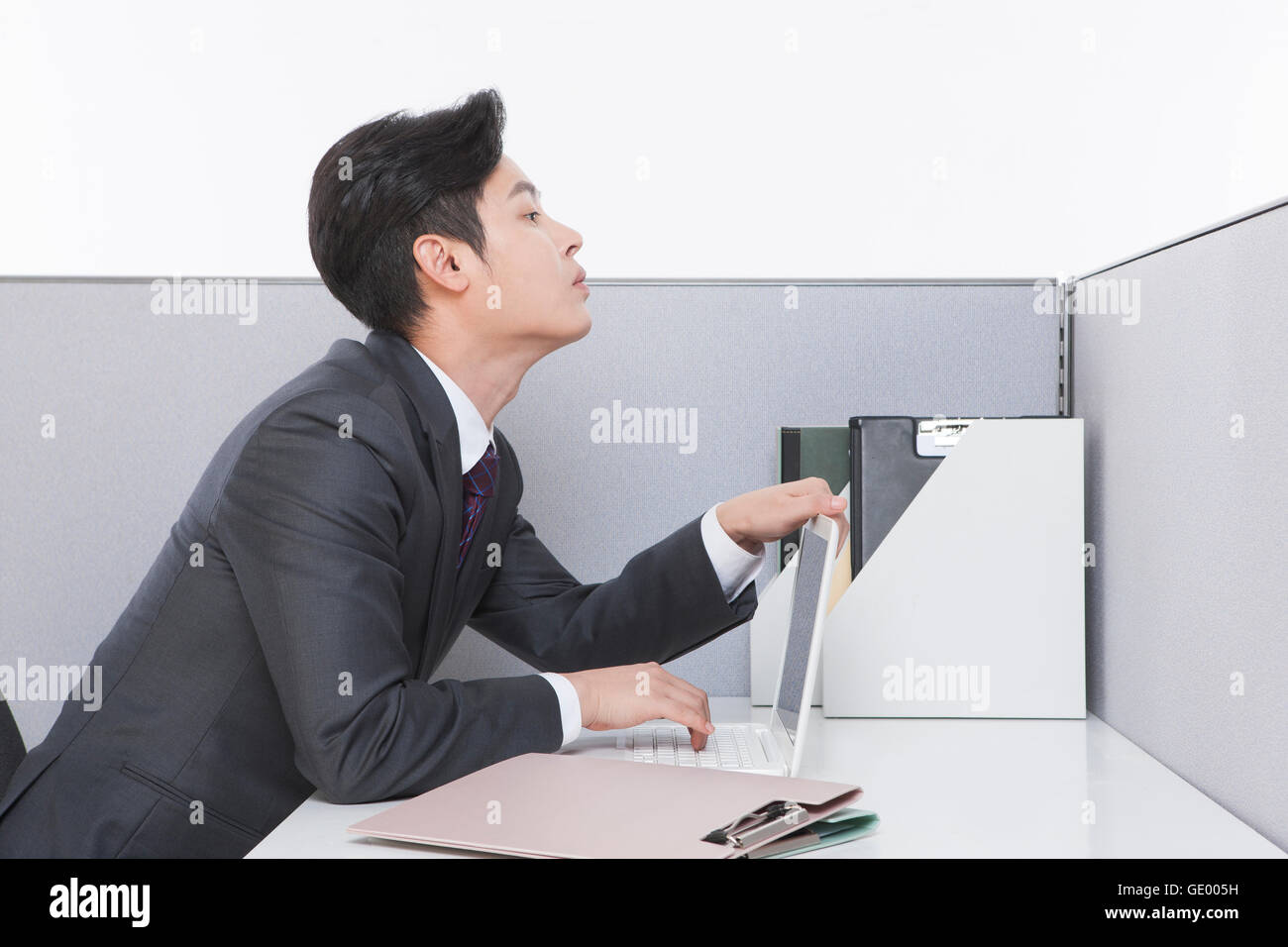 Side view portrait of young businessman having a peek at work Stock ...