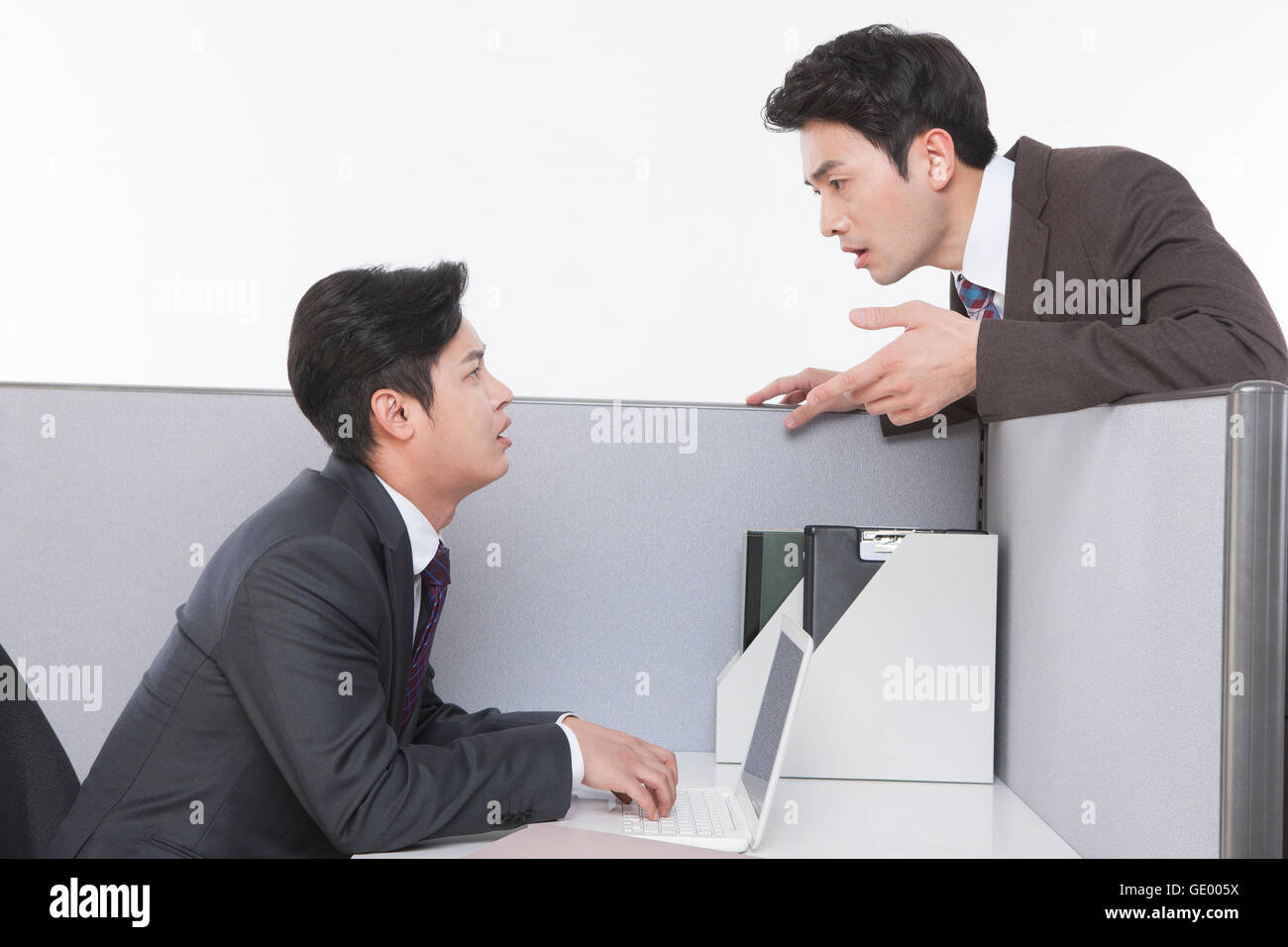 Side view p of two businessmen face to face at work Stock Photo - Alamy