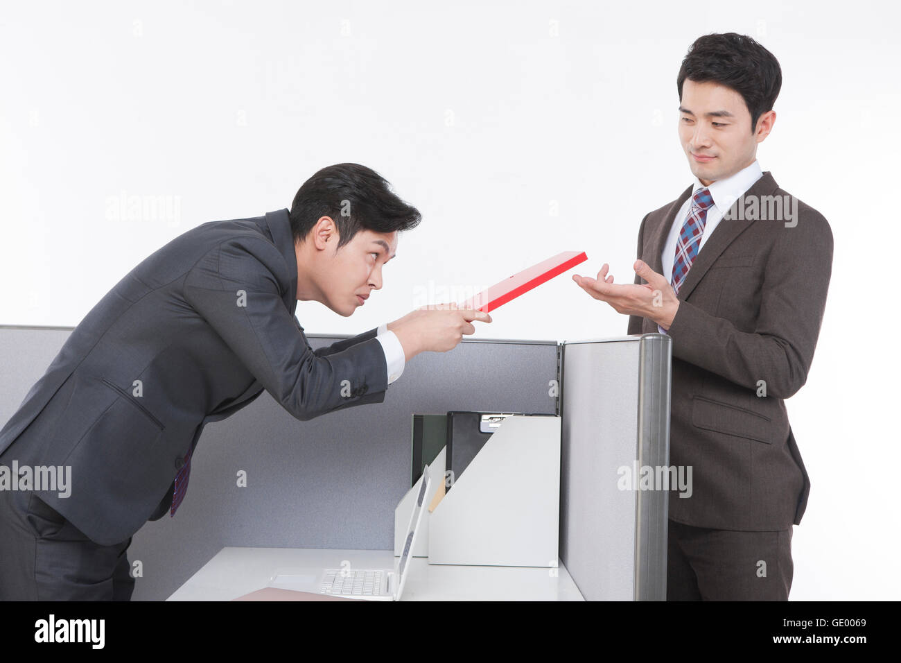 Side view of business man giving a file to his supervisor at work ...