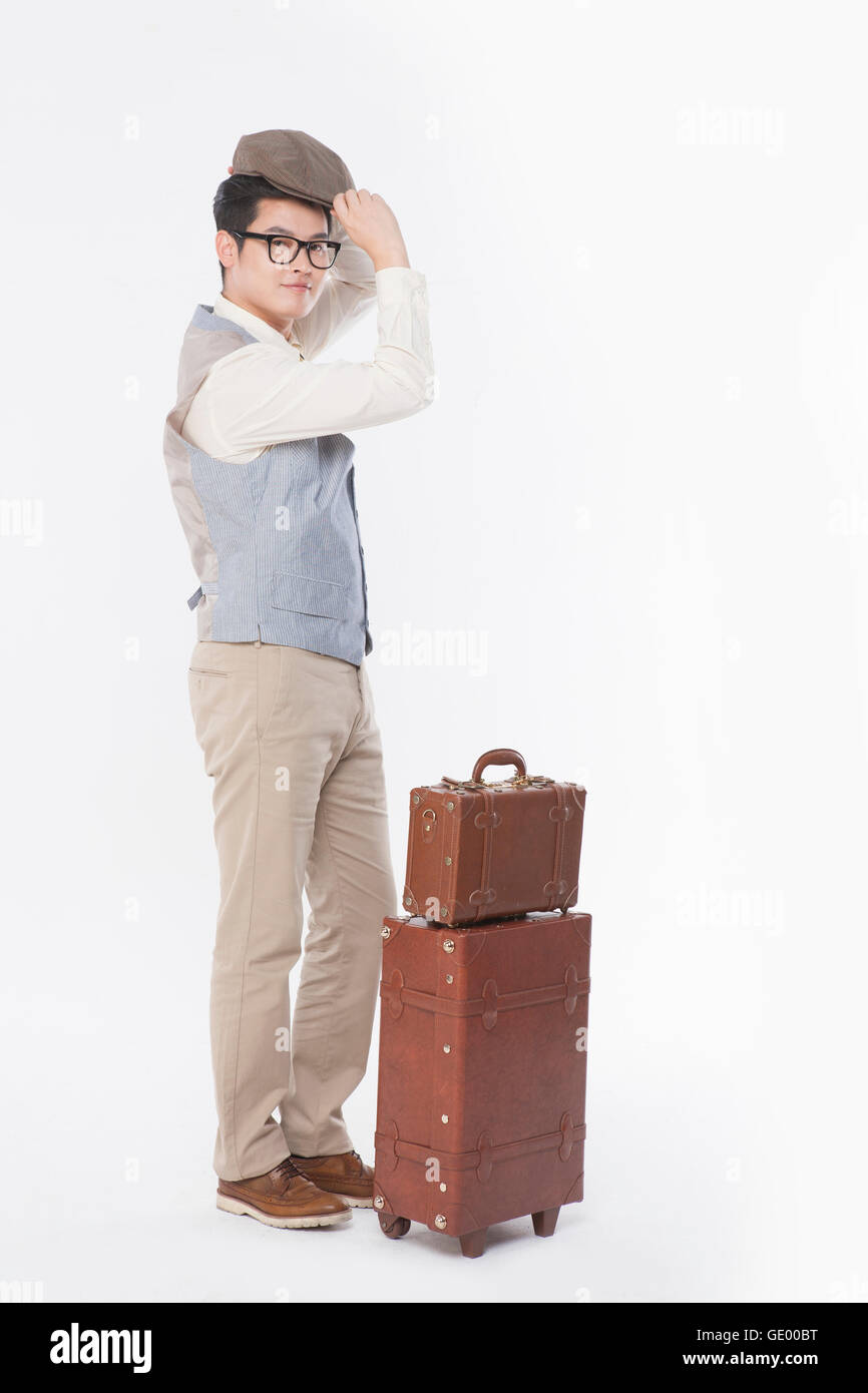 Side view of businessman in retro style putting on his cap standing ...