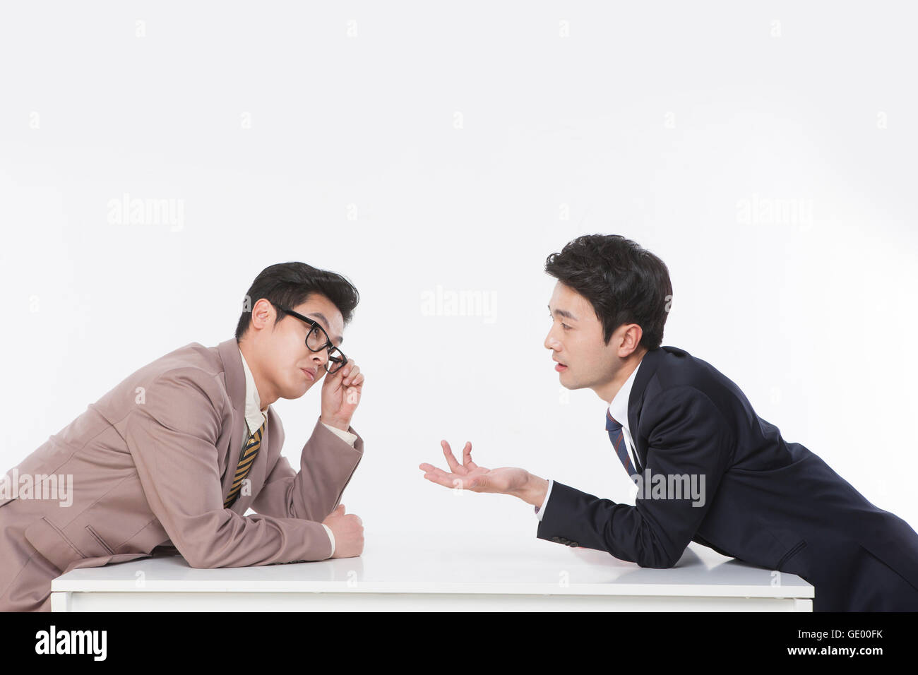 Side view of two business men at table having a talk face to face Stock ...