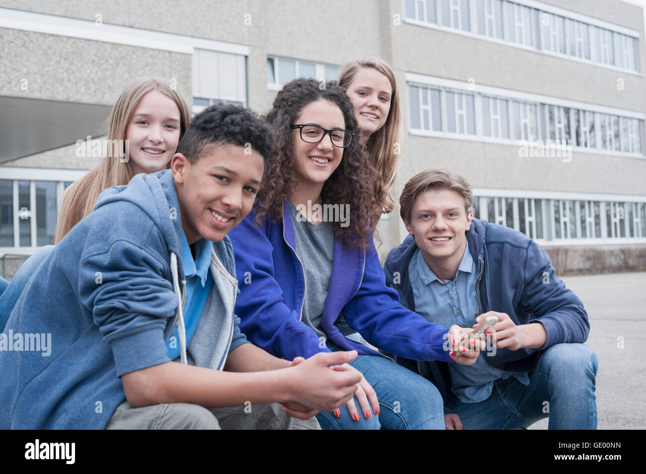 University students sitting in campus and smiling, Bavaria, Germany ...