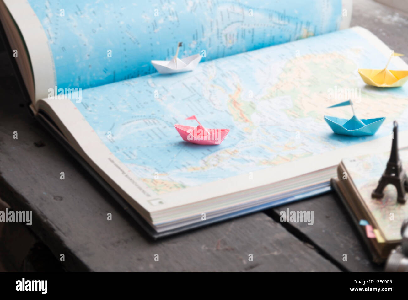 Travel to World. Tourism. Paper boats on the map Stock Photo - Alamy