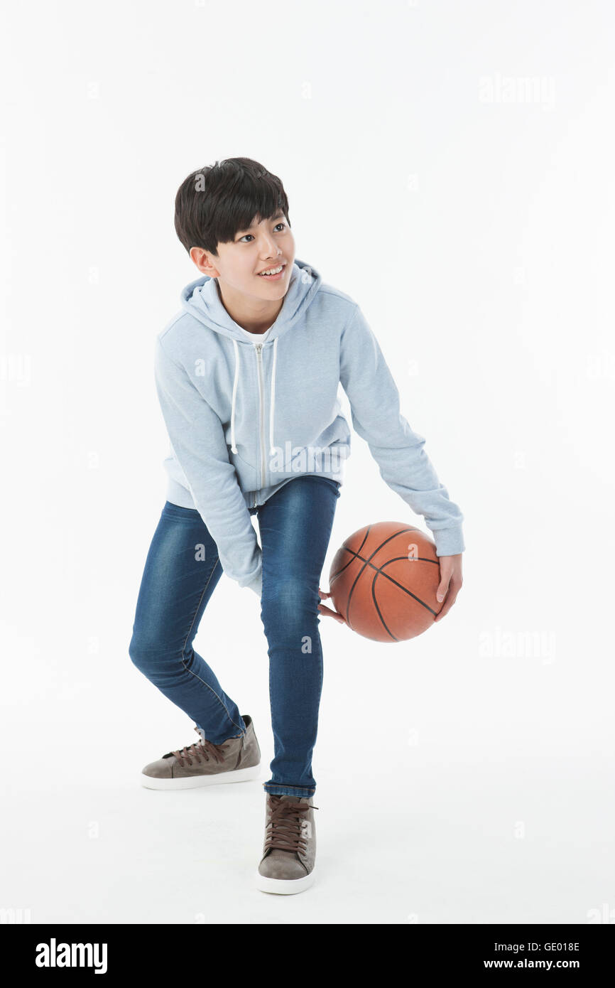 Smiling school boy with a basketball standing Stock Photo - Alamy