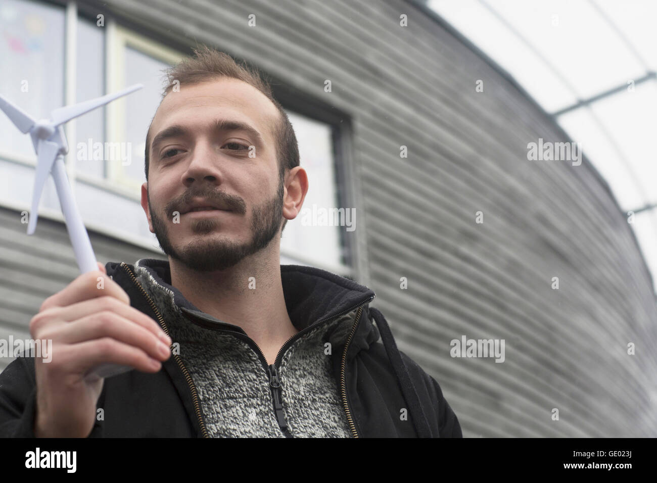 Male engineer looking at model of windmill in the city, Freiburg im ...