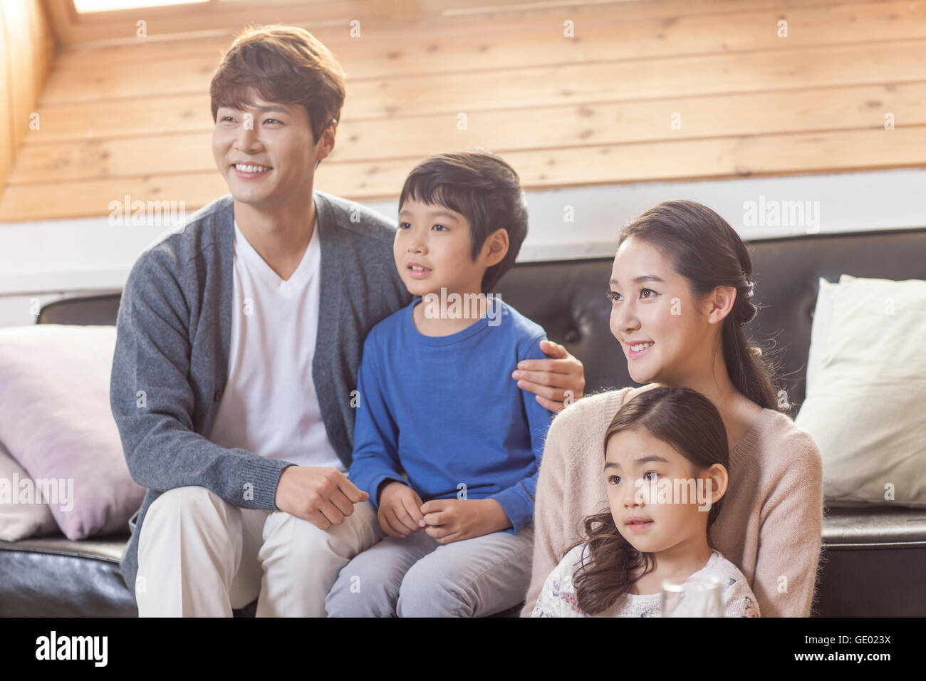 Harmonious family in living room Stock Photo - Alamy