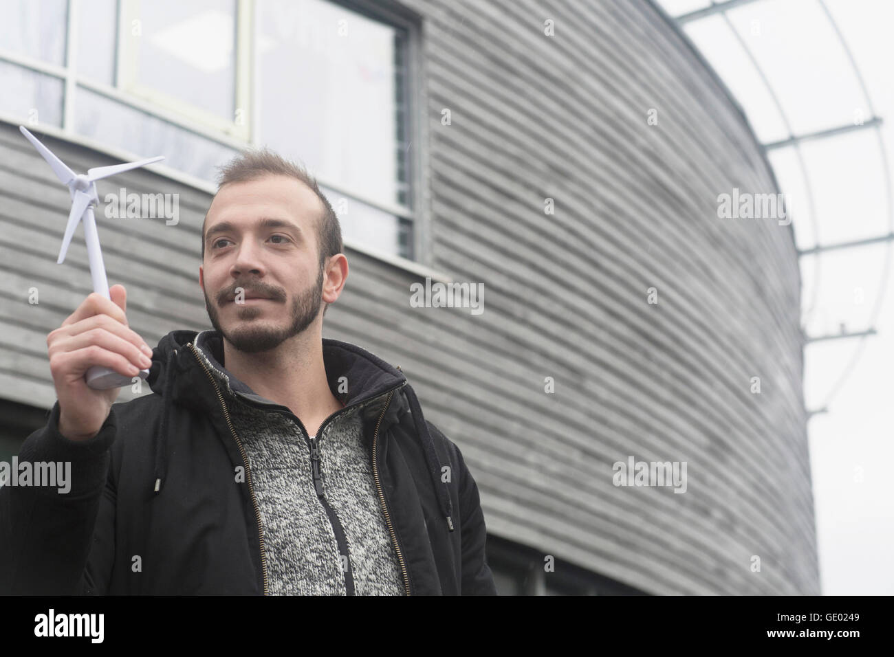 Male engineer looking at model of windmill in the city, Freiburg im ...
