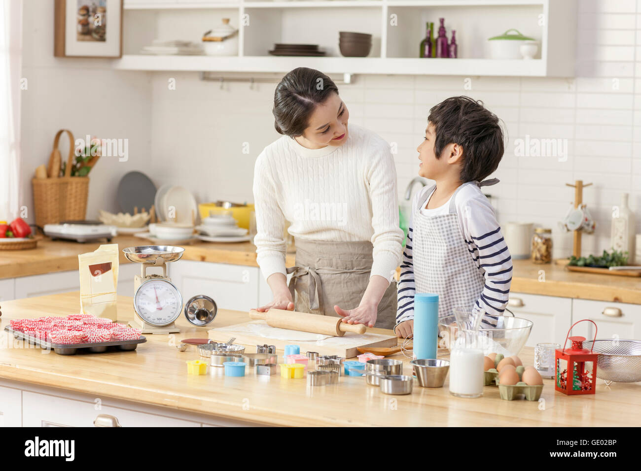 Smiling mother and son cooking together in kitchen Stock Photo - Alamy