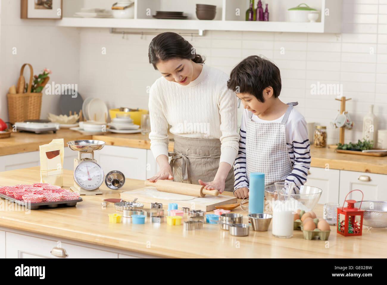 Smiling mother and boy cooking together in kitche Stock Photo - Alamy