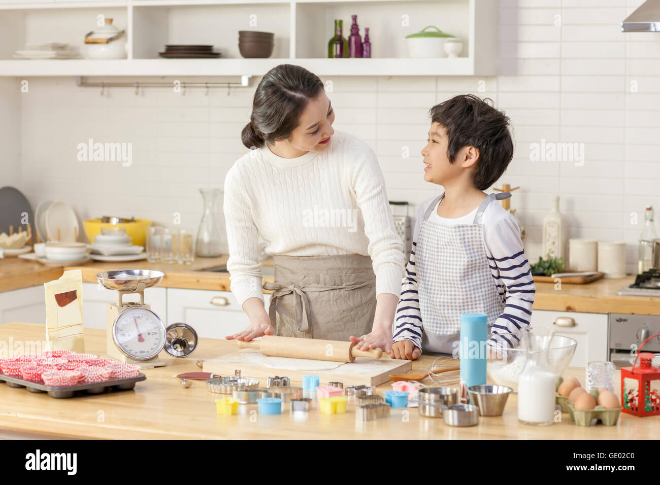 Mother and son smiling at each other during cooking in kitchen0 Stock ...