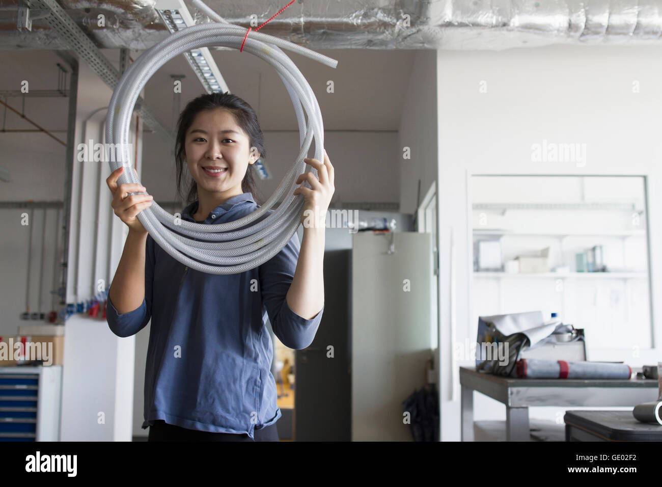 Young female engineer with pipe in an industrial plant, Freiburg im ...