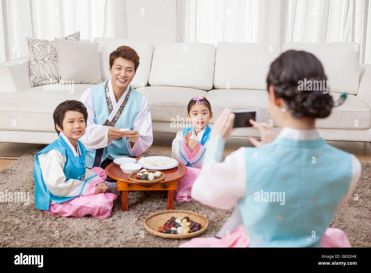Korean mother taking picture of her family in traditional Korean ...