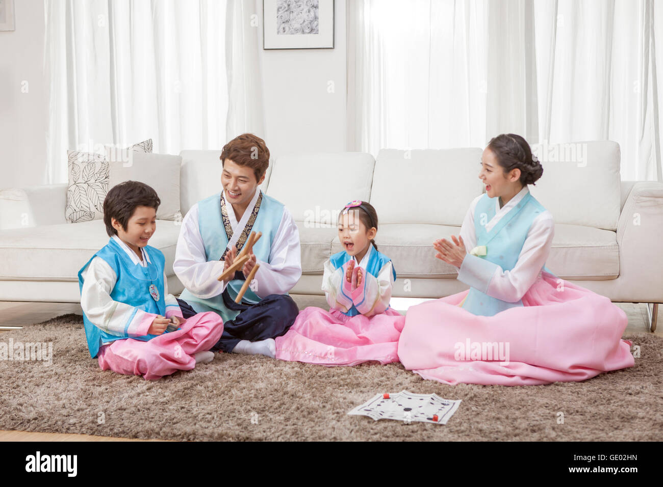 Harmonious family playing yut hi-res stock photography and images - Alamy