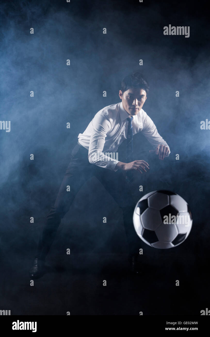 Serious business man standing and ready to block a soccer ball Stock ...