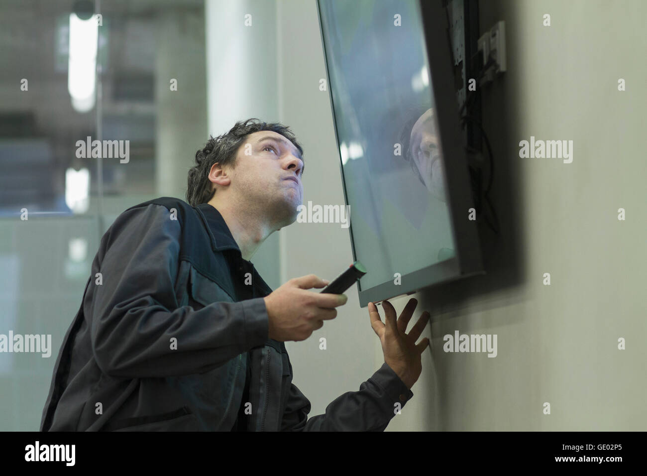 Repairman repairing television in the office, Freiburg im Breisgau ...