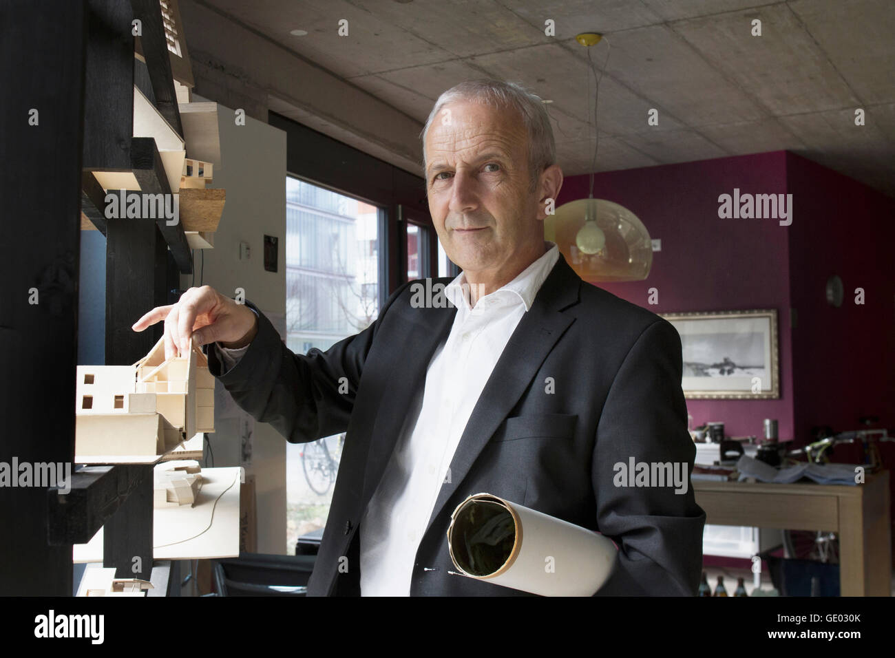 Portrait of a senior architect with architectural model in the office ...