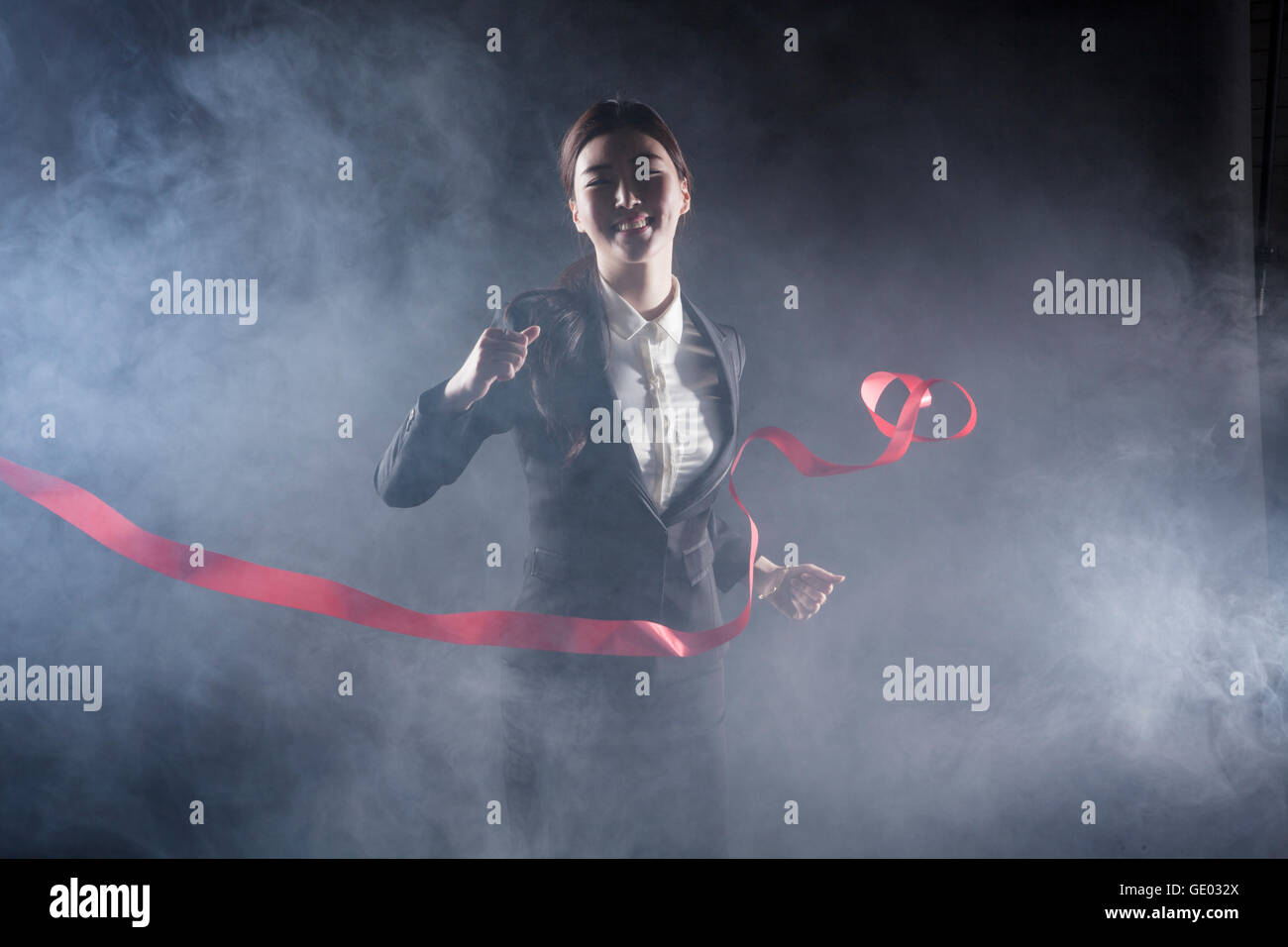 Portrait of business woman crossing a finish line Stock Photo - Alamy