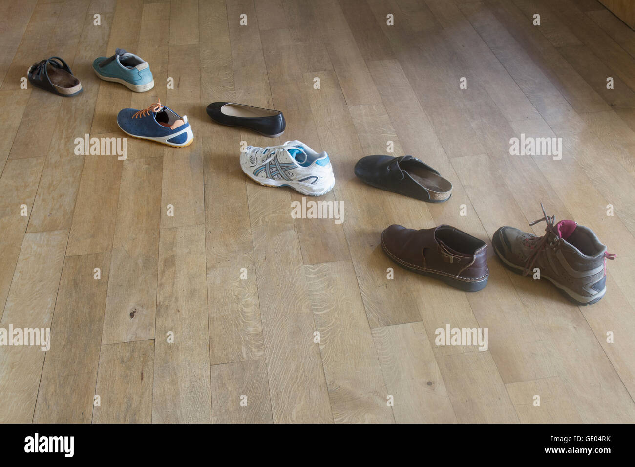 Variety of shoes on wooden floor Stock Photo - Alamy