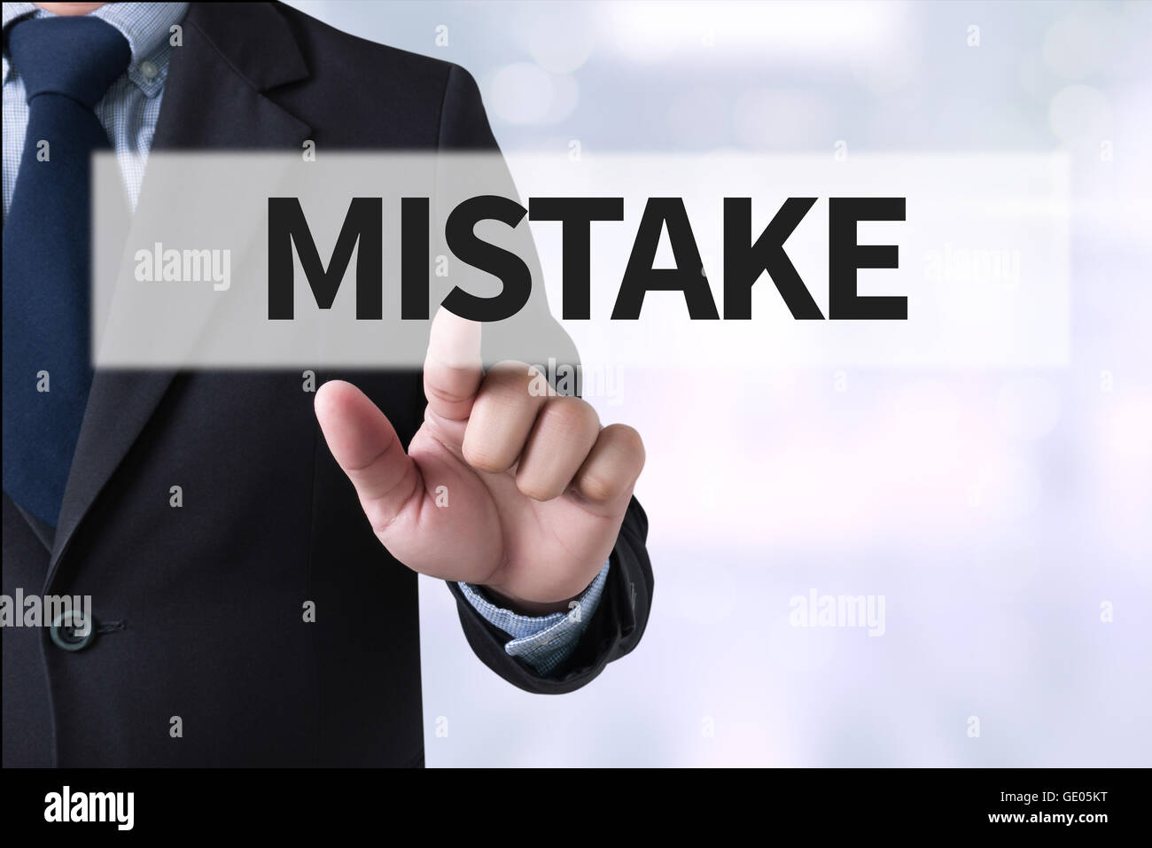 MISTAKE Businessman hands touching on virtual screen and blurred city ...