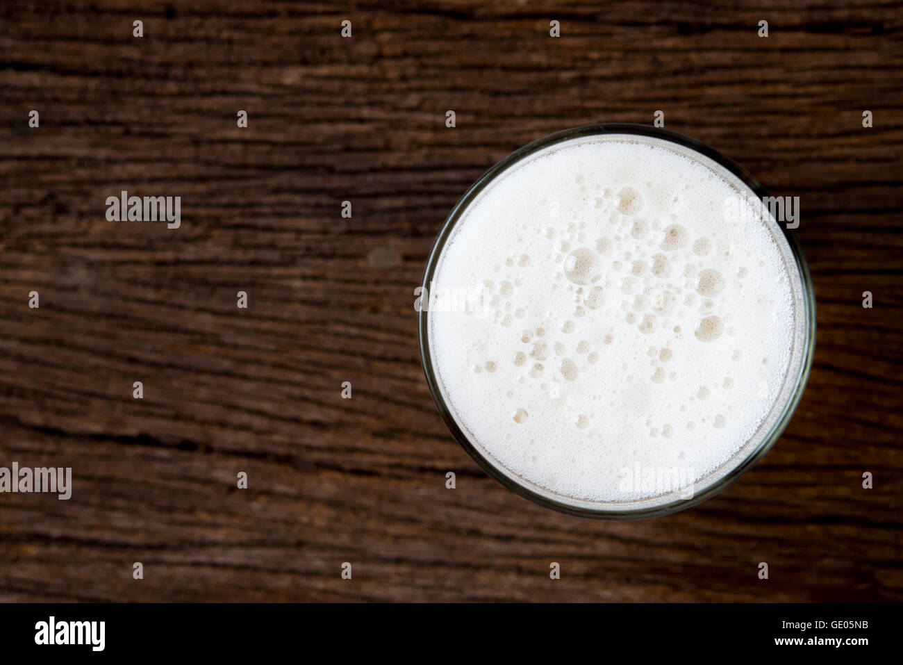 top view of beer glass with foam on old wood table Stock Photo - Alamy