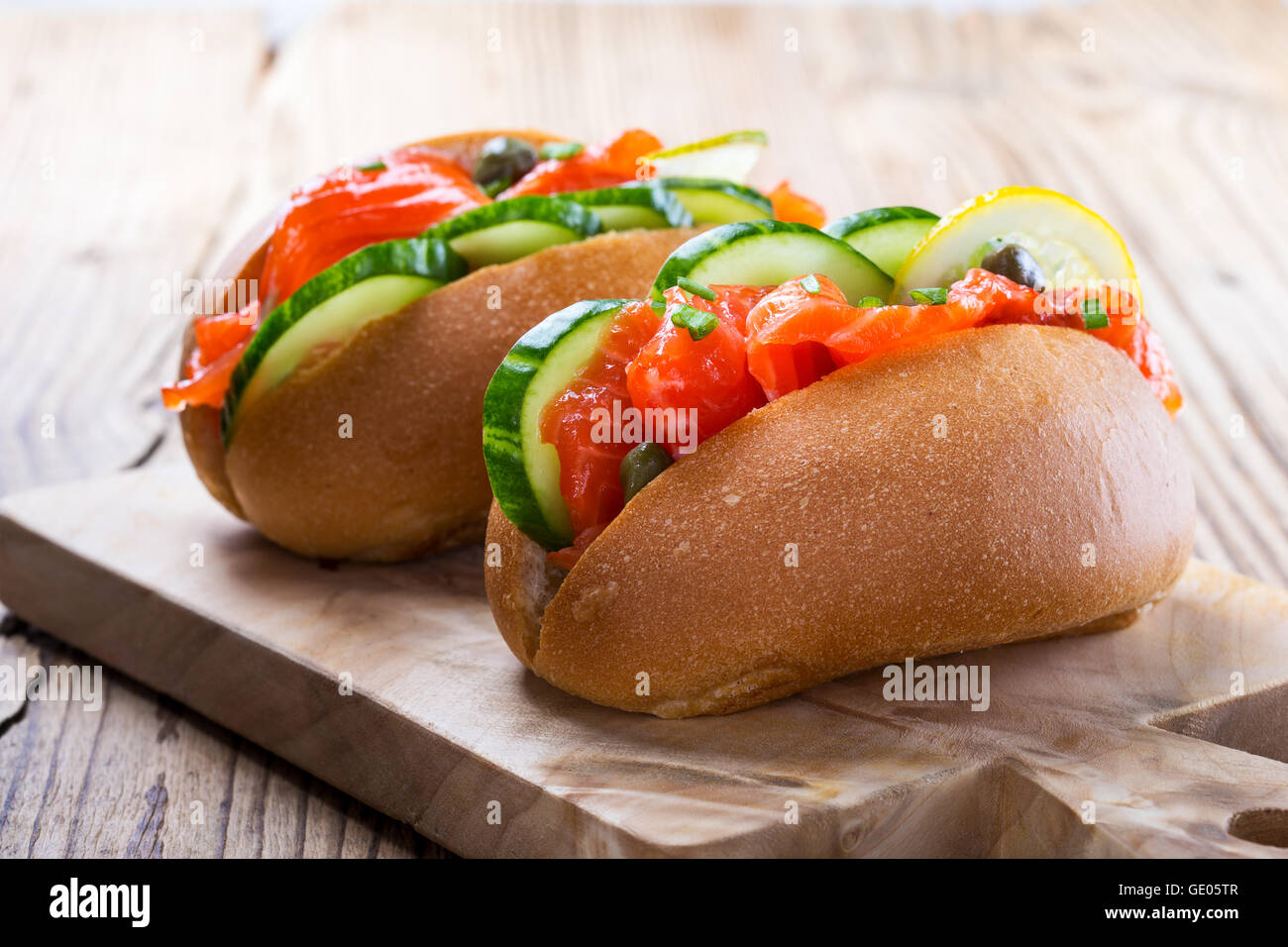 Smoked salmon bun sandwich with cucumber and capers Stock Photo - Alamy