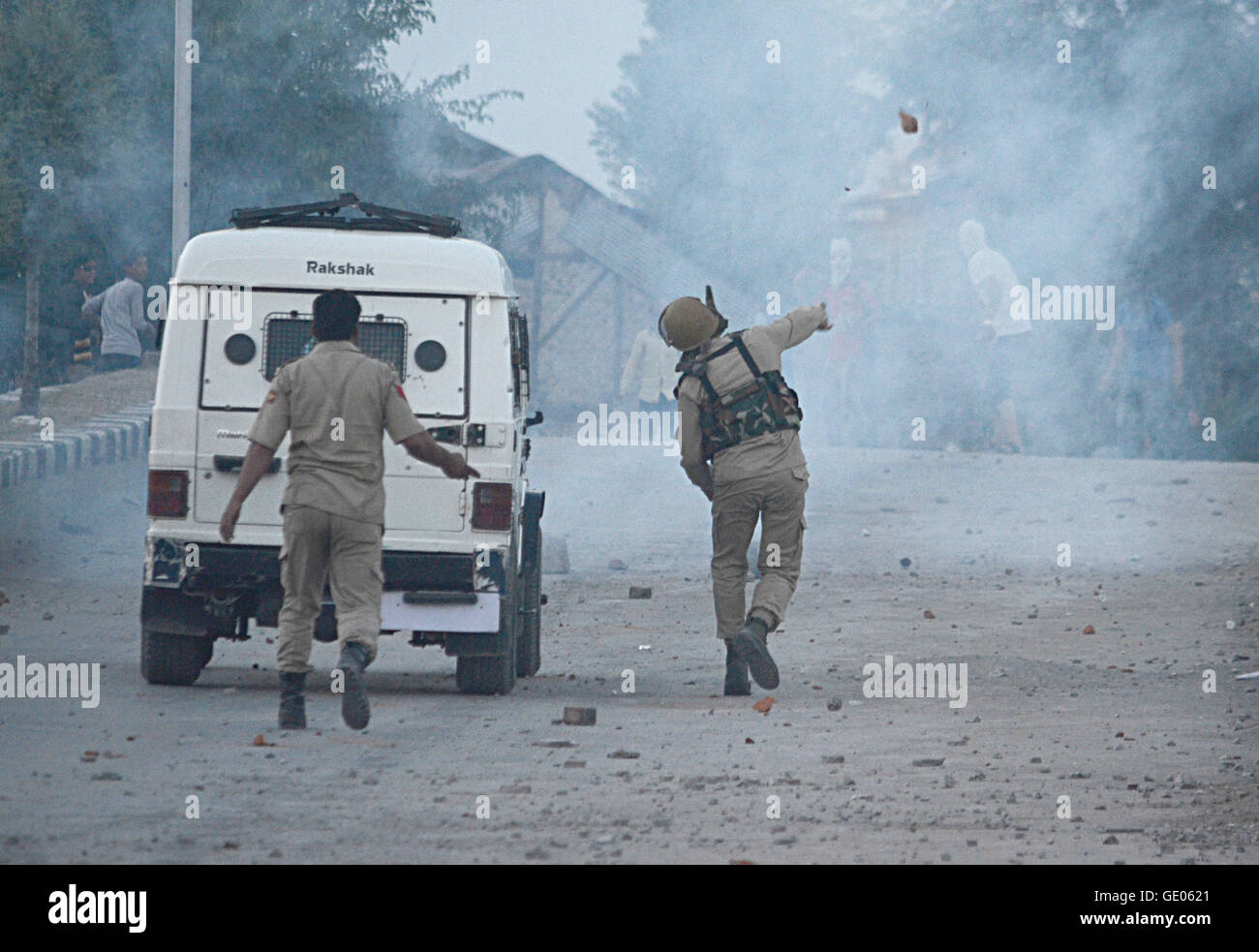 An Indian policeman retaliates during anti India clashes in Srinagar ...