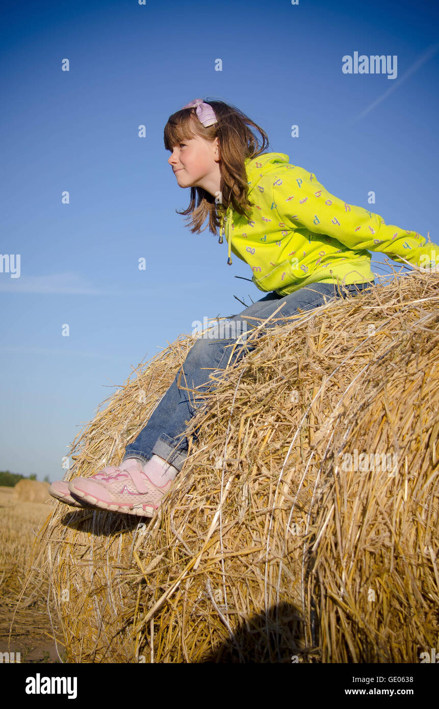 girl sitting in a haystack Stock Photo - Alamy