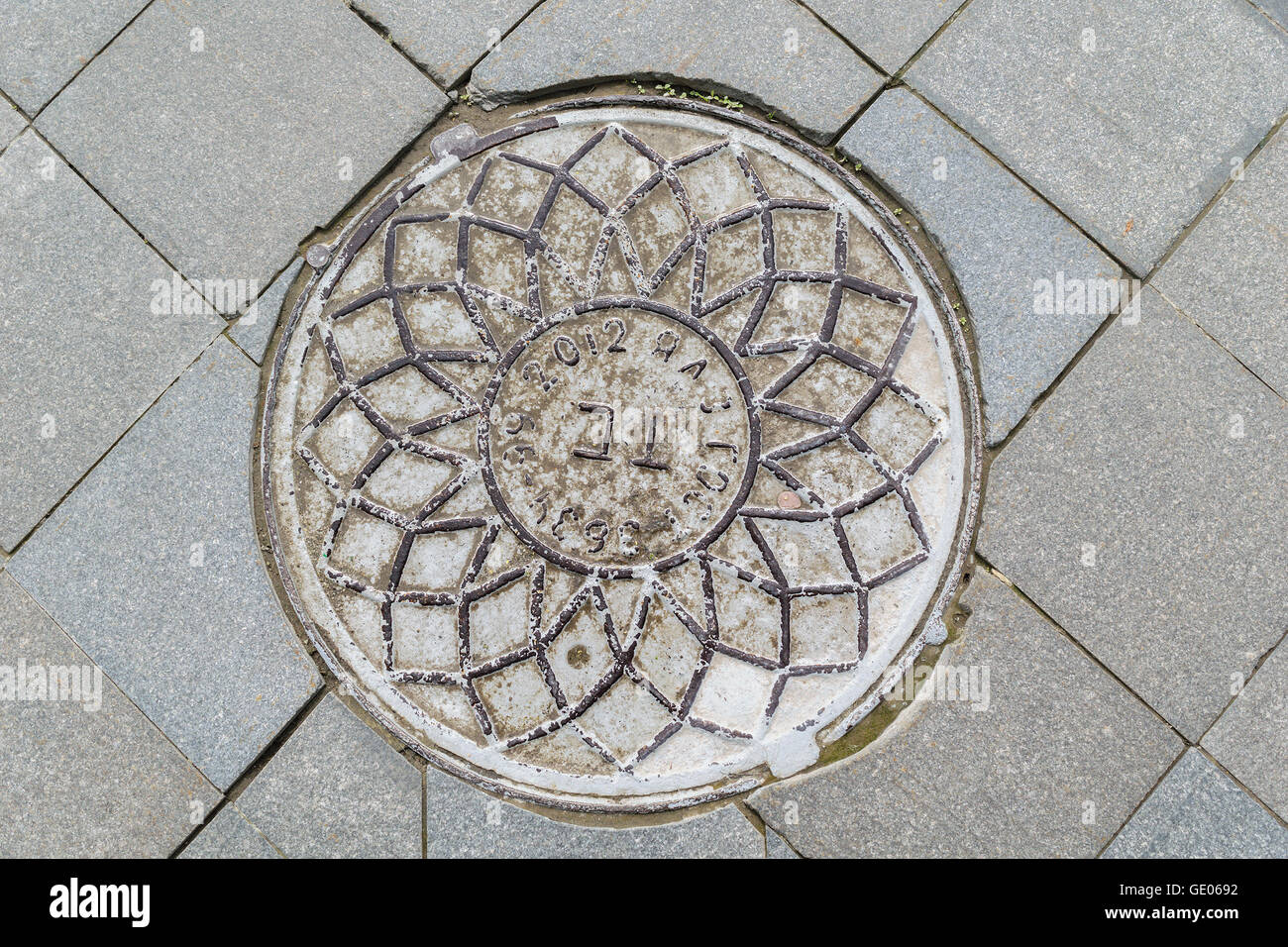 Metal manhole cover with ornaments covering the technology pit to ...