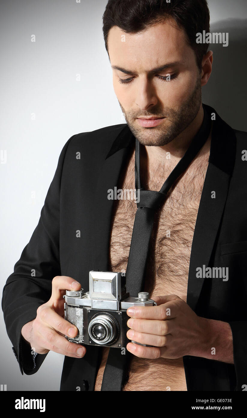 Attractive man taking photo Stock Photo - Alamy