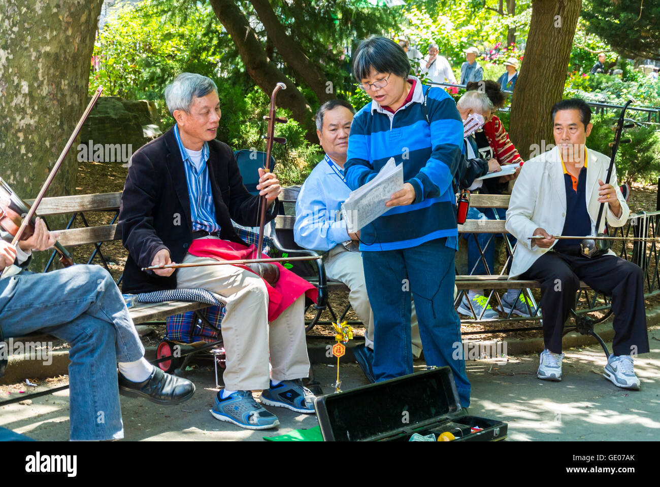 Playing traditional music instruments park chinatown neighborhood hi ...