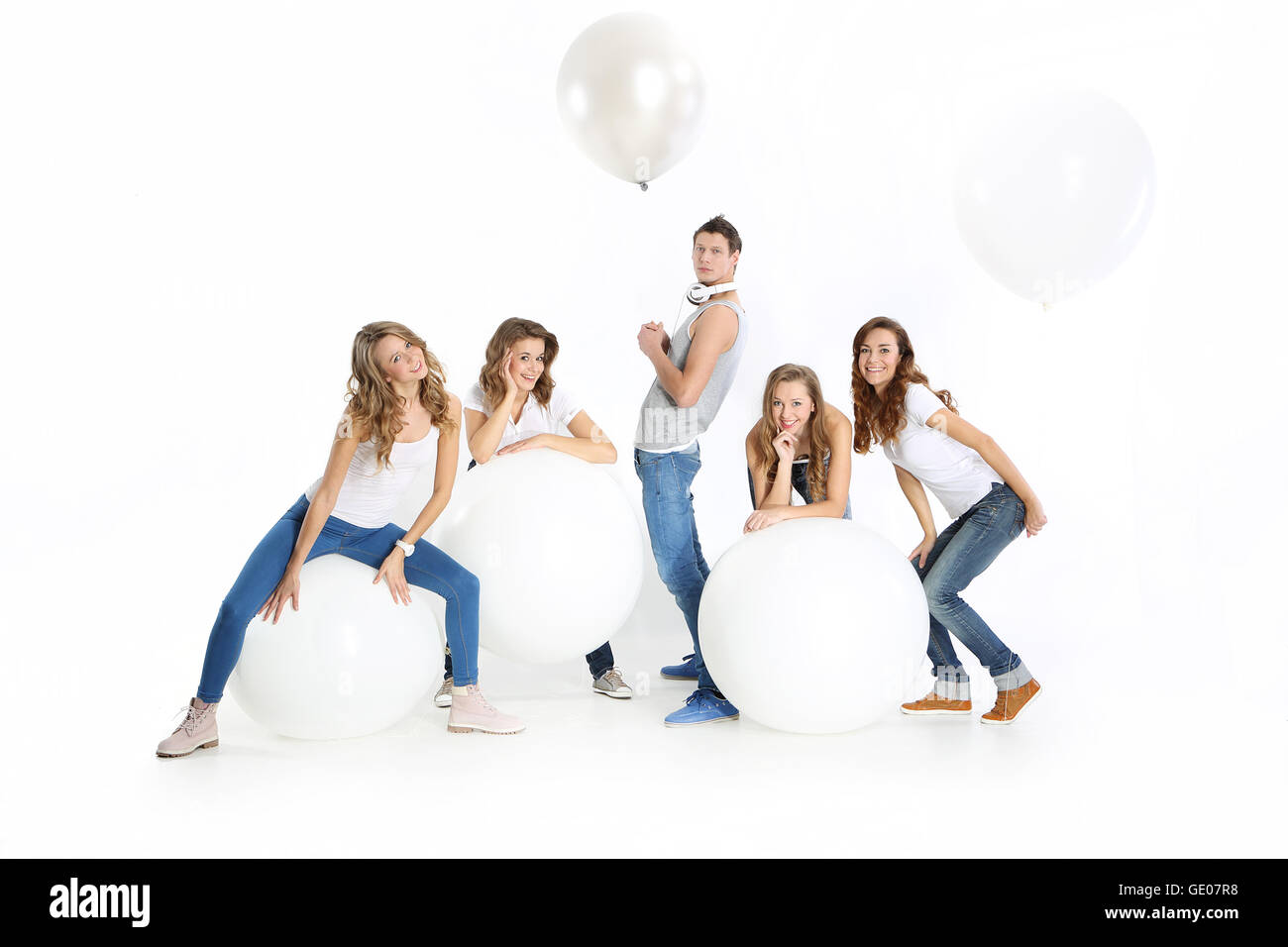 The team of young people with huge white balloons Stock Photo - Alamy