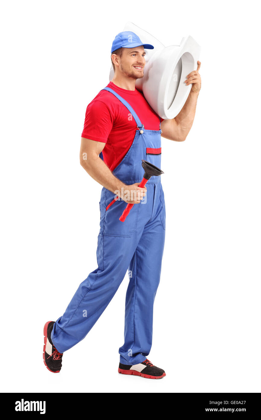 Full length portrait of a cheerful male plumber carrying a toilet and a ...
