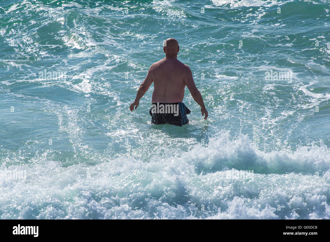 A holidaymaker cooling off in the sea at Fistral Beach in Newquay ...