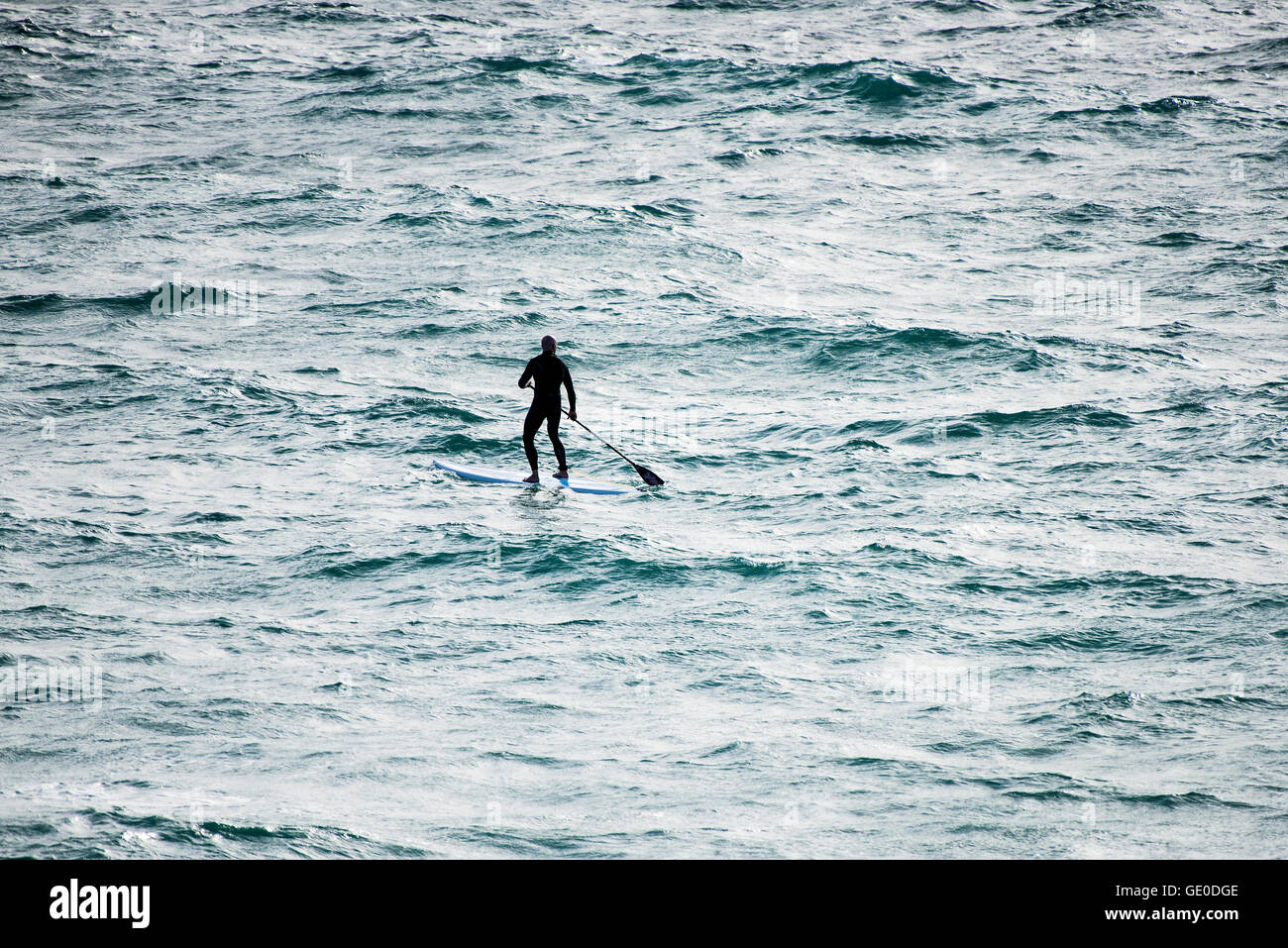A paddle boarder on the sea off the Cornish coast Stock Photo - Alamy