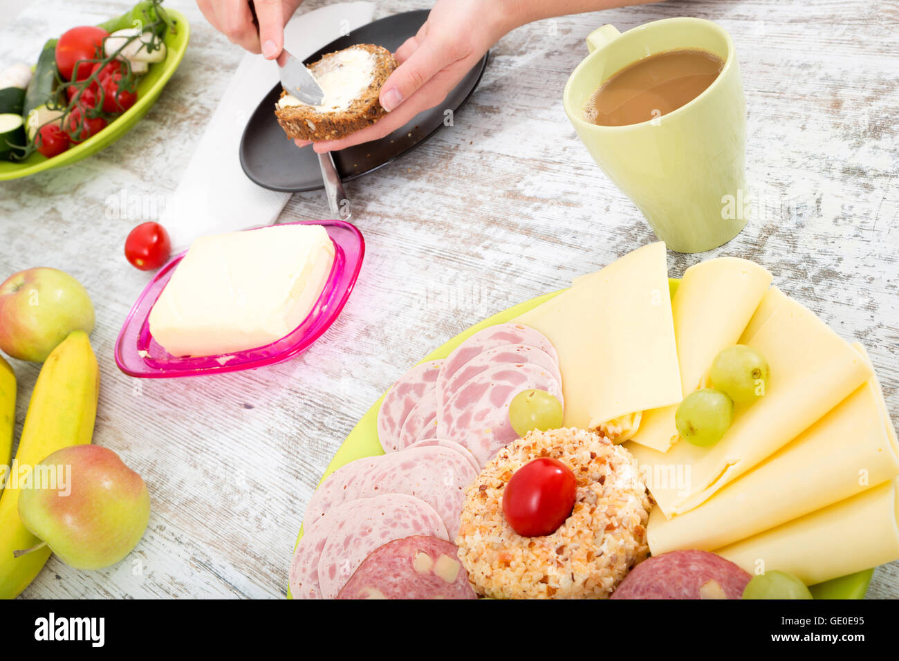 A woman having a breakfast at a table Stock Photo - Alamy