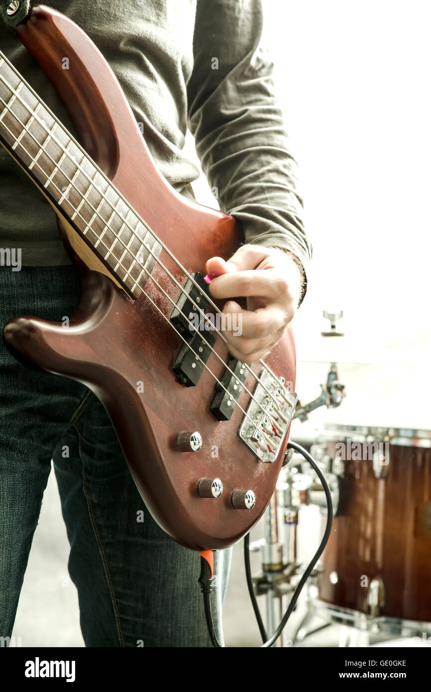 A Rock musician playing bass in the rehearsal Studio Stock Photo - Alamy