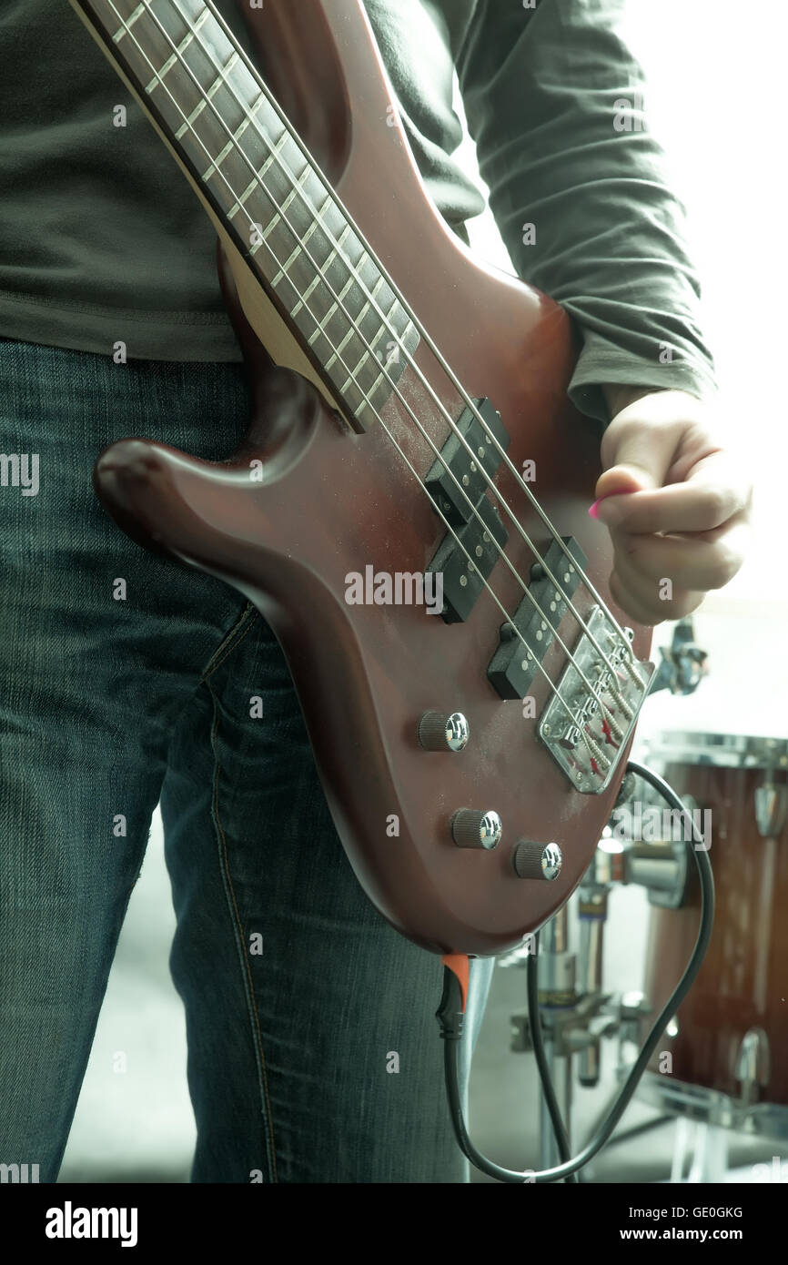 A Rock musician playing bass in the rehearsal Studio Stock Photo - Alamy