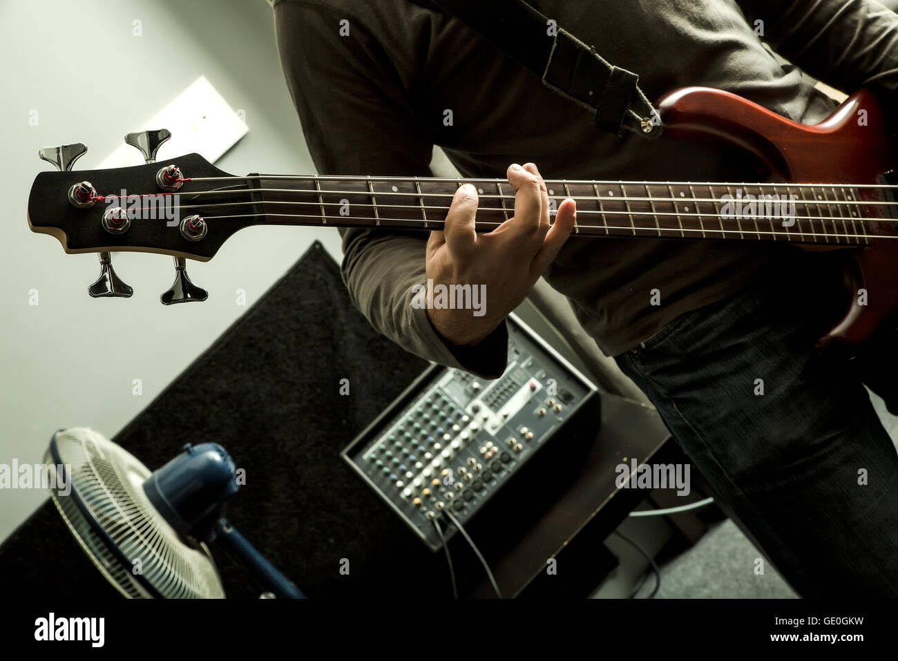 A rock musician playing the bass in a rehearsal room Stock Photo - Alamy