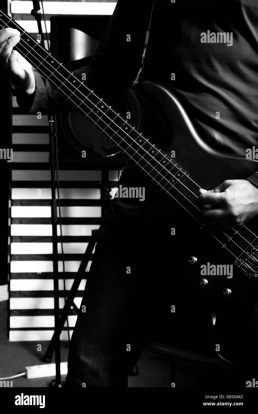 A rock musician playing the bass in a rehearsal room Stock Photo - Alamy