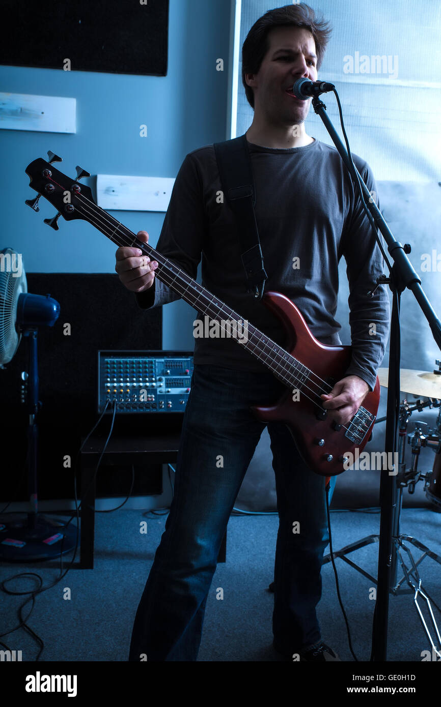 Black and white Portrait of a Rock singer playing bass in the rehearsal ...