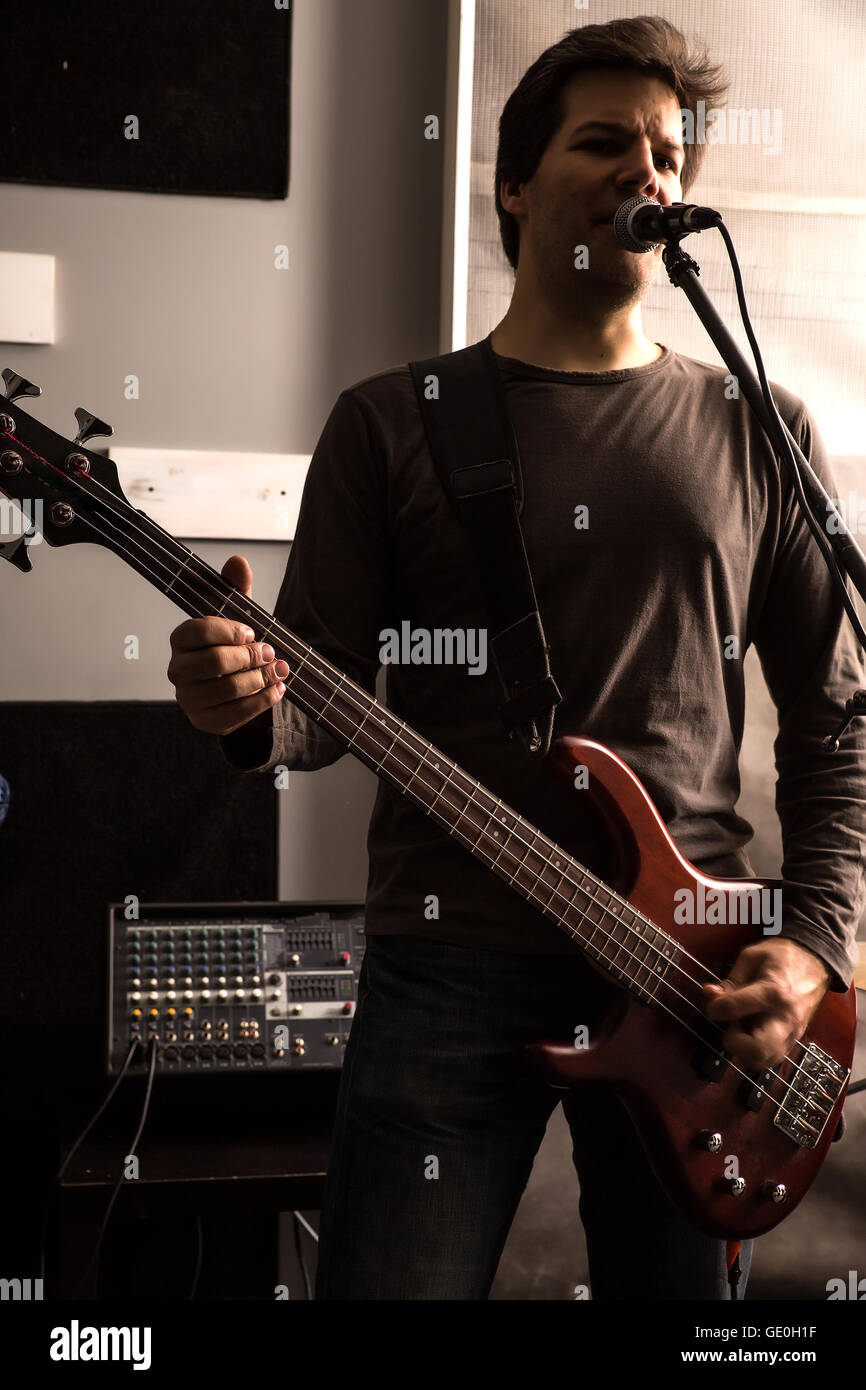 Black and white Portrait of a Rock singer playing bass in the rehearsal ...