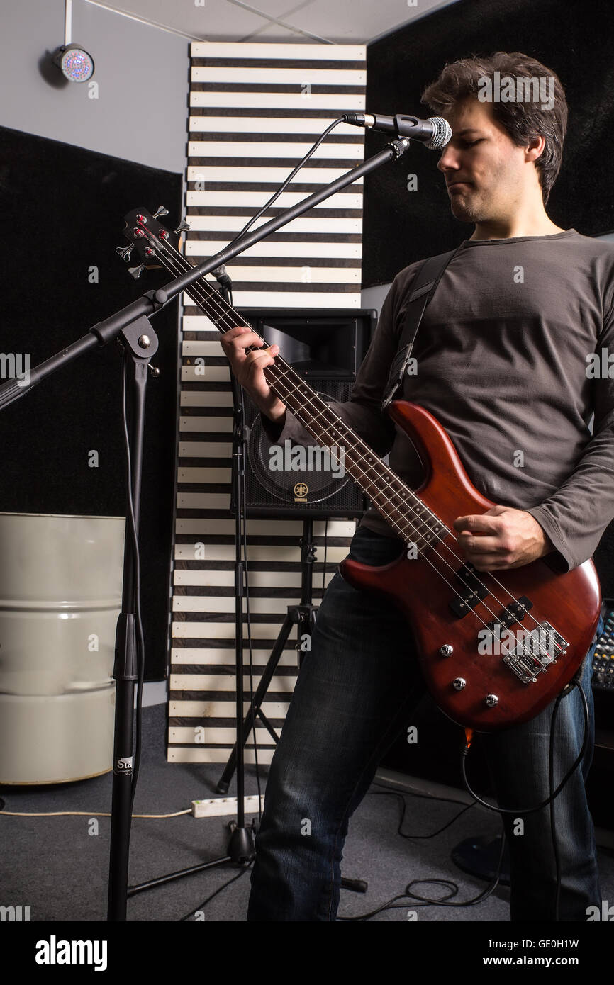 Black and white Portrait of a Rock singer playing bass in the rehearsal ...