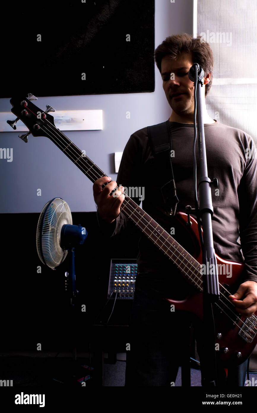 Black and white Portrait of a Rock singer playing bass in the rehearsal ...