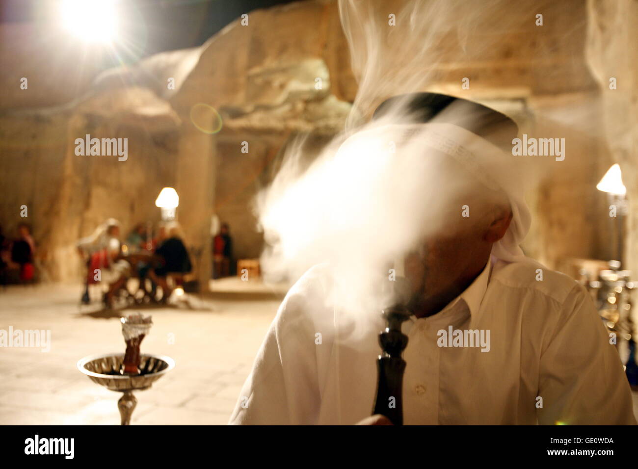a Men smoking a Waterpipe in a cafe shop in the Village of Wadi Musa ...