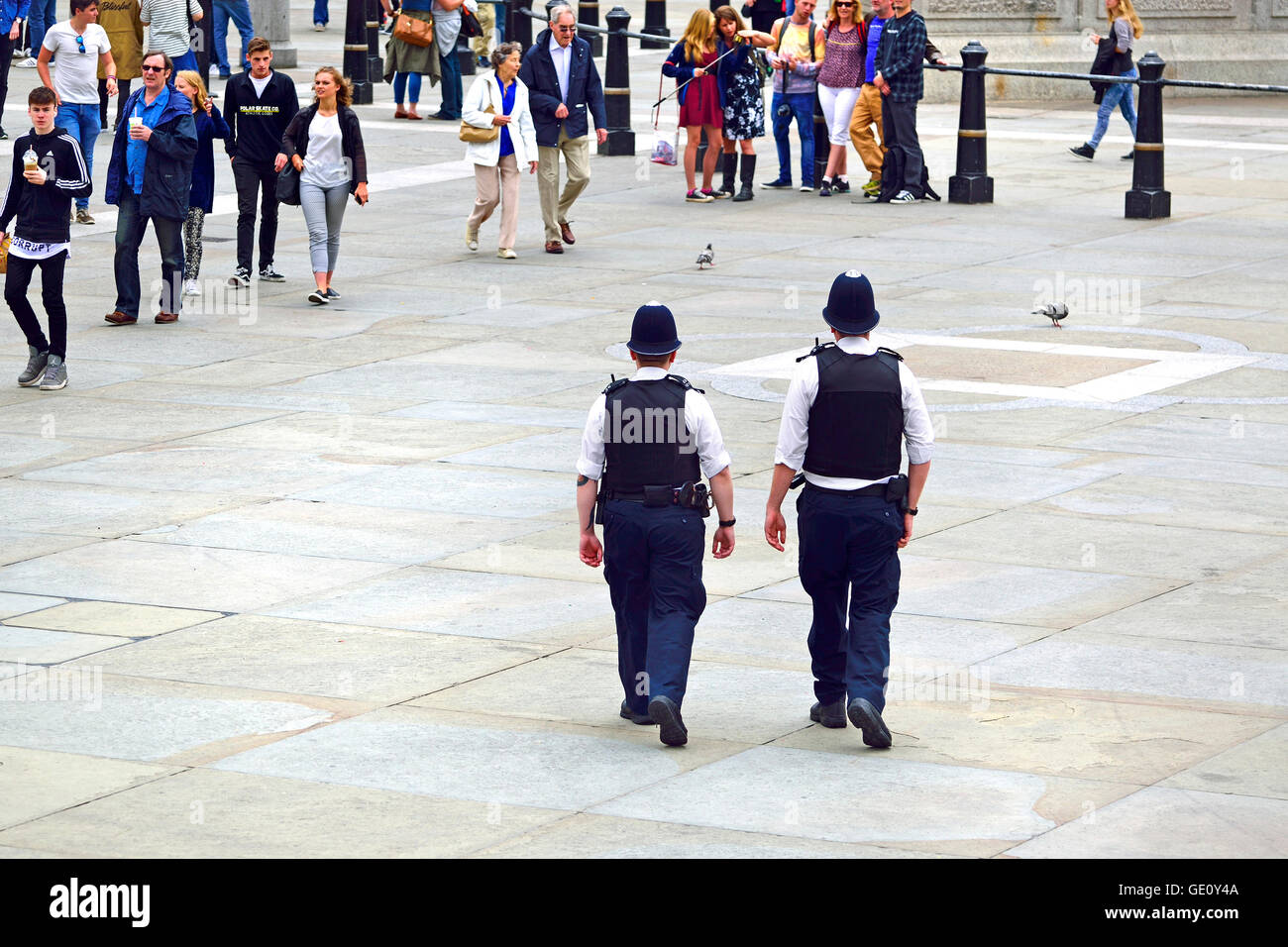 London, England, UK. Two police officers on duty in Trafalgar Square ...