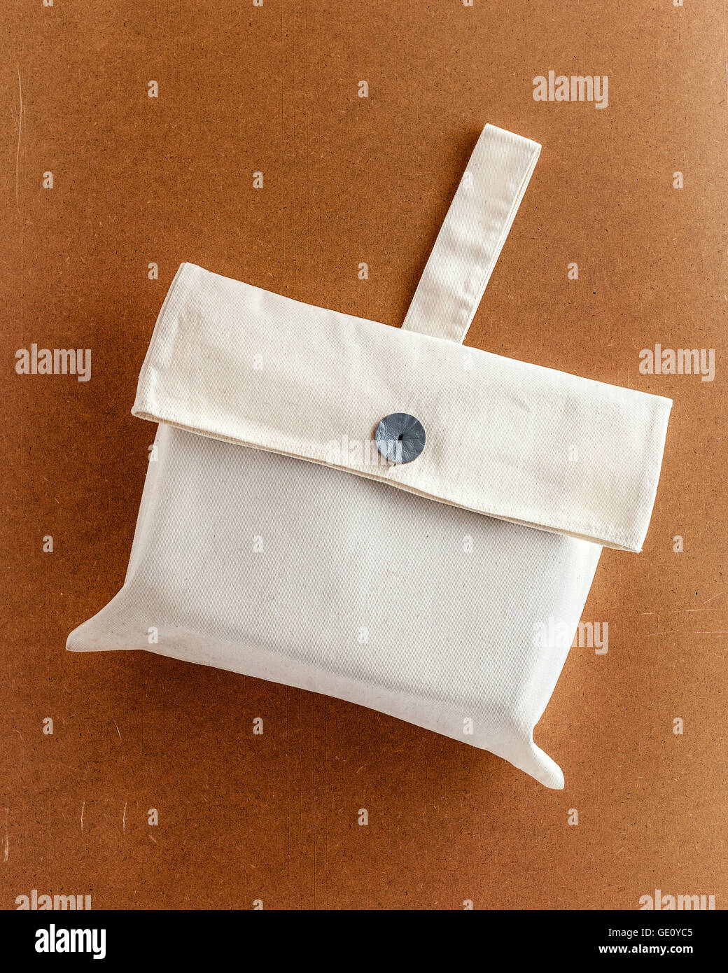 Fabric bag cover with holder on brown eco background Stock Photo - Alamy
