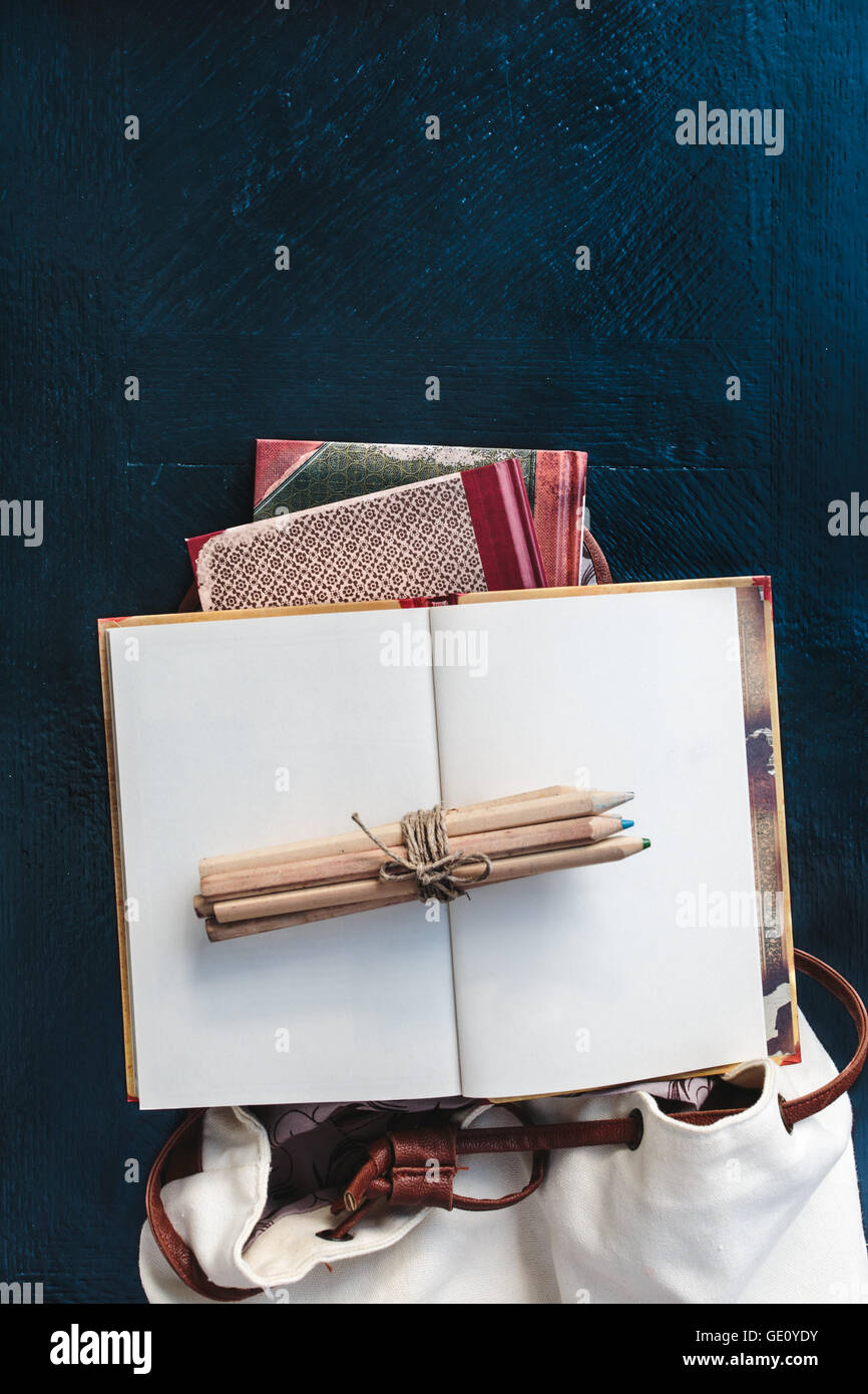Notebooks pencils and school bag on a desktop Stock Photo - Alamy