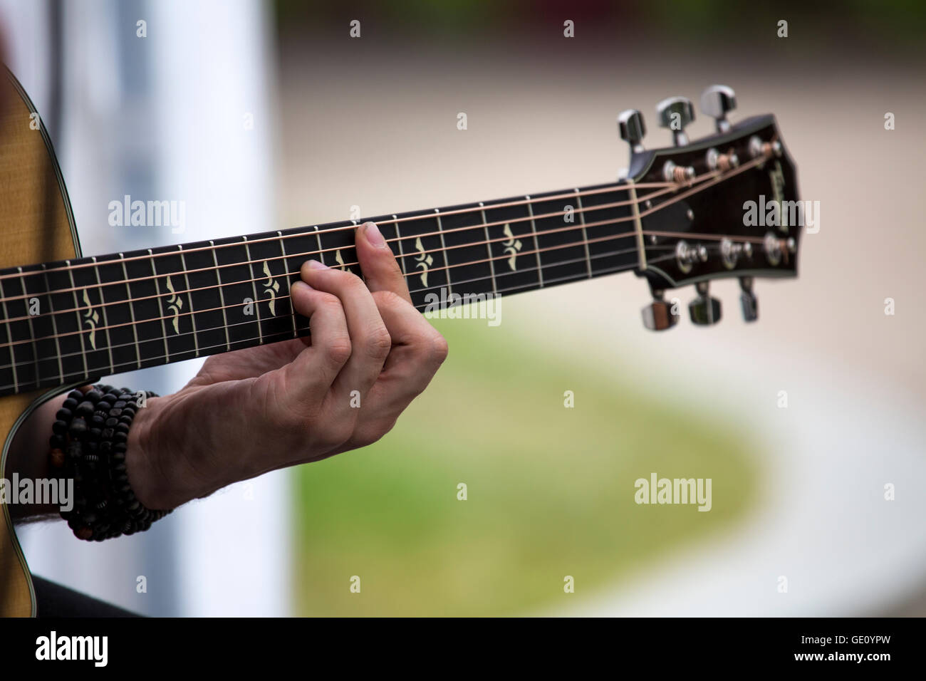 A guitar being played by a musician Stock Photo - Alamy