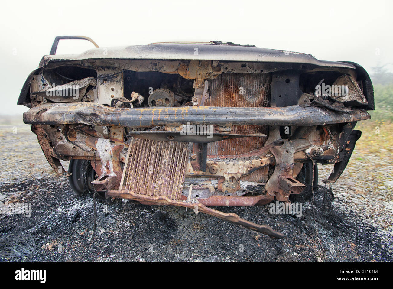 Front view of a burnt out truck left abandoned on common ground Stock ...